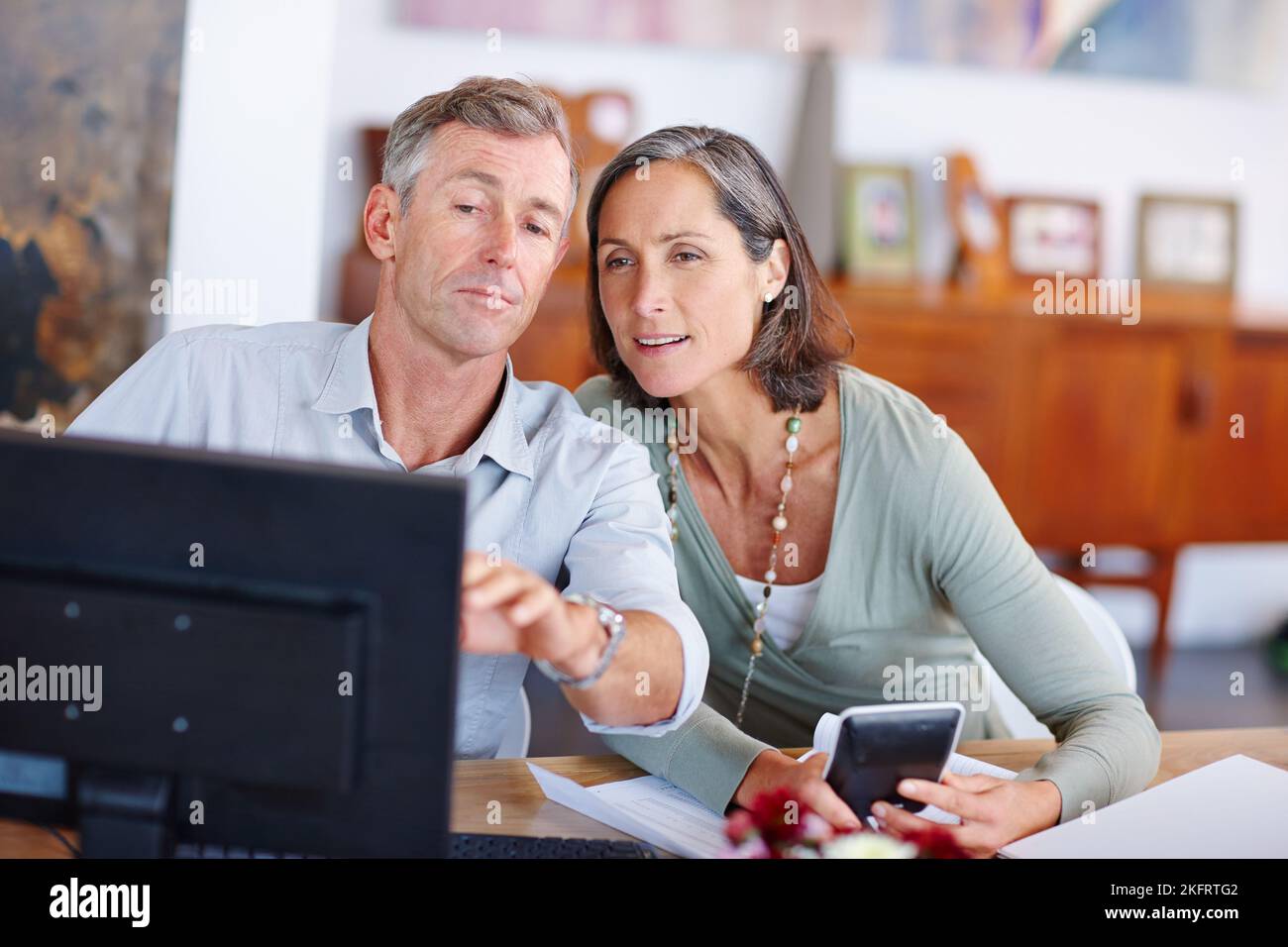 Woman sorting through bills hi-res stock photography and images - Alamy