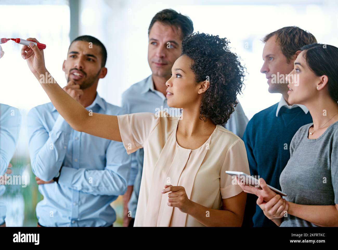 Ideas are a group effort. a diverse group of coworkers brainstorming in ...