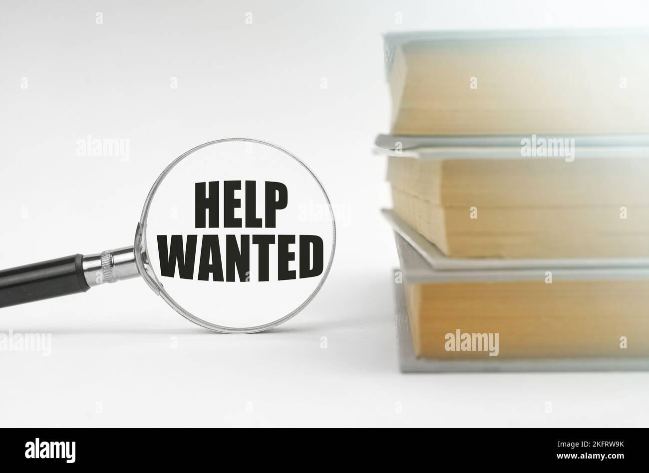 Business concept. On a white background, books and a magnifying glass ...