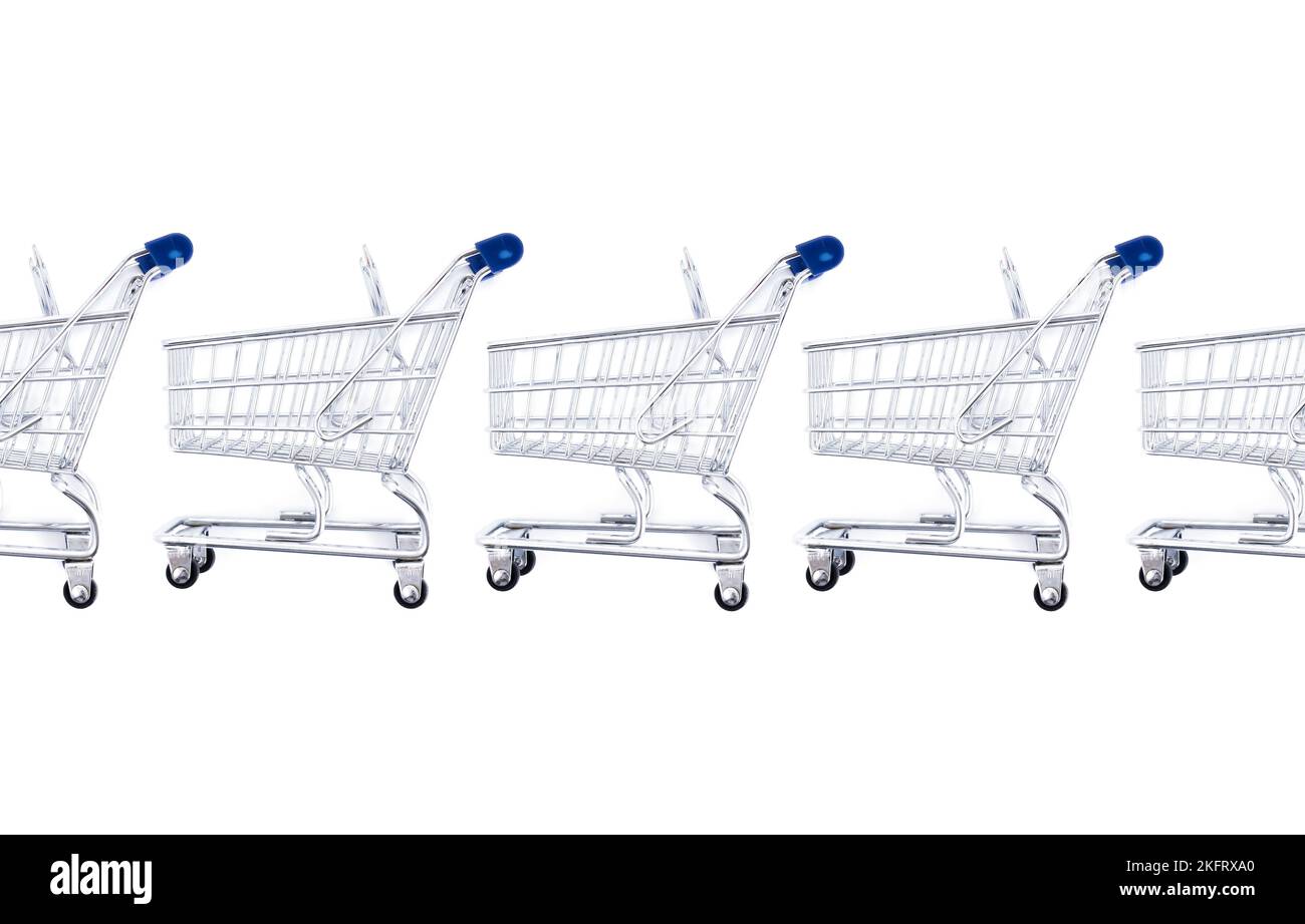 empty shopping carts in the line over white background, mini metal ...