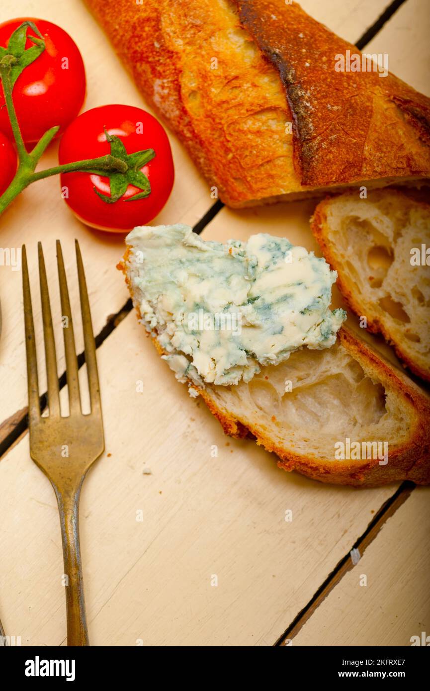 Fresh blue cheese spread ove french baguette with cherry tomatoes on ...