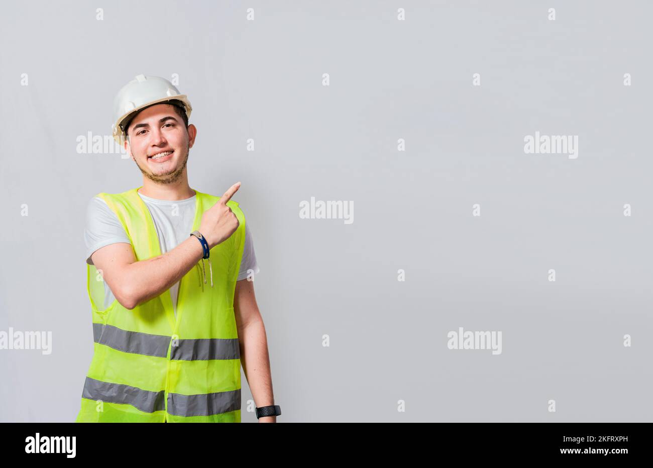 Engineer man pointing to side. Builder engineer pointing finger to the ...