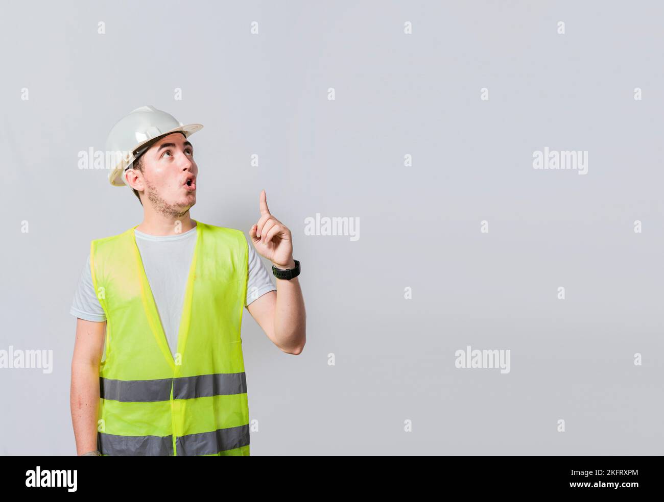 Engineer man pointing up. Surprised face engineer pointing finger to ...