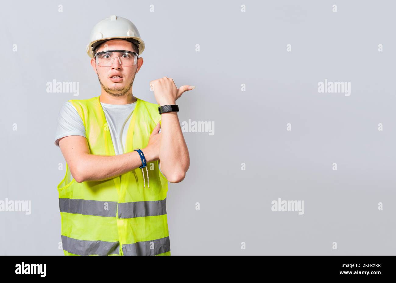 Amazed Engineer pointing to side. Surprised engineer pointing finger to ...