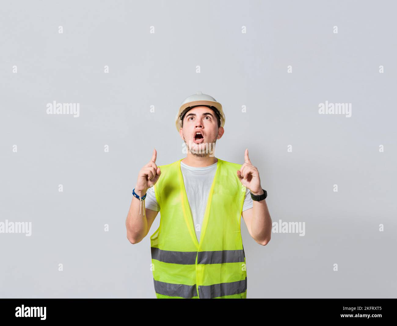 Amazed engineer pointing at an advertisement. Concept of an engineer ...