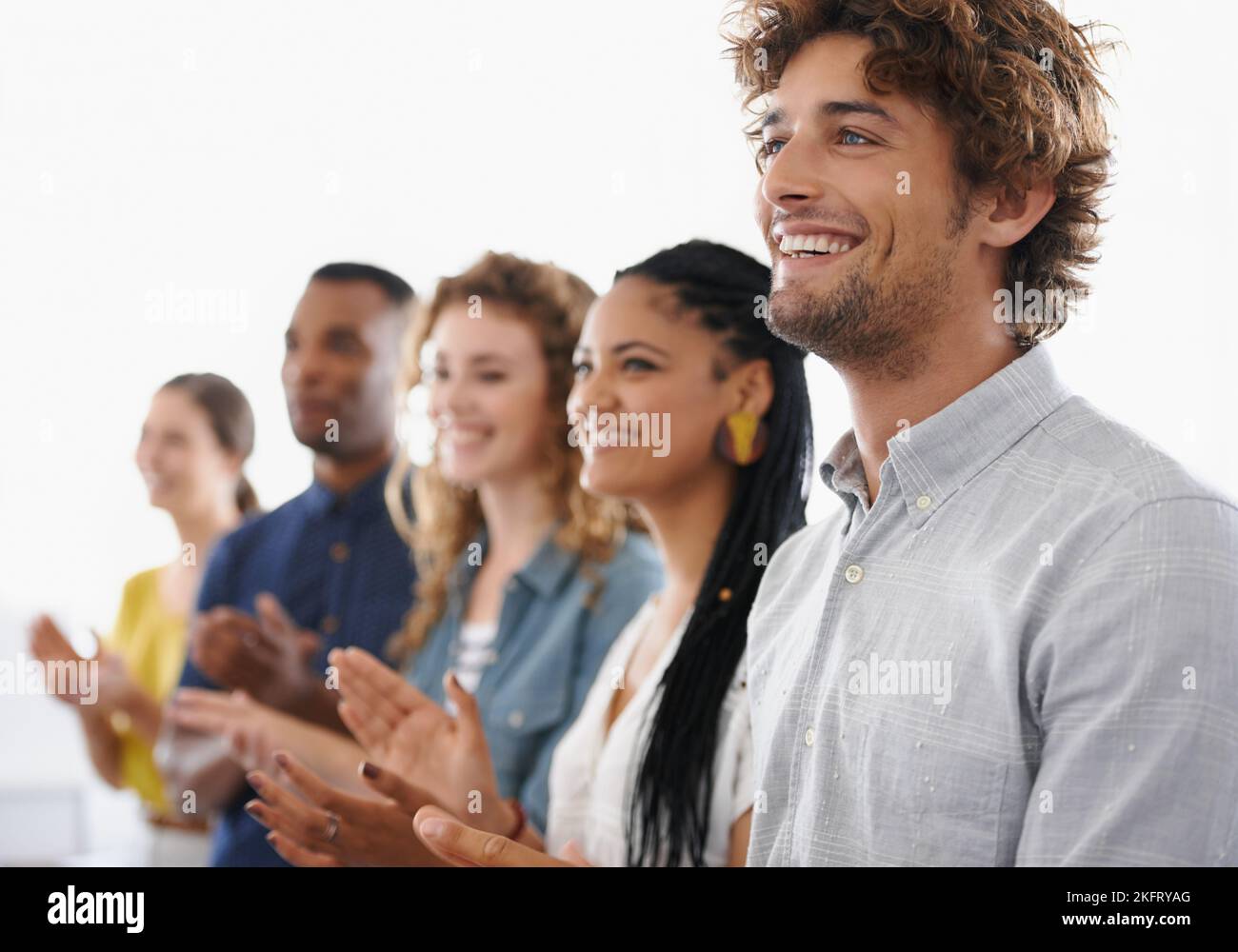 Hear, Hear. a group of smiling office workers clapping Stock Photo - Alamy