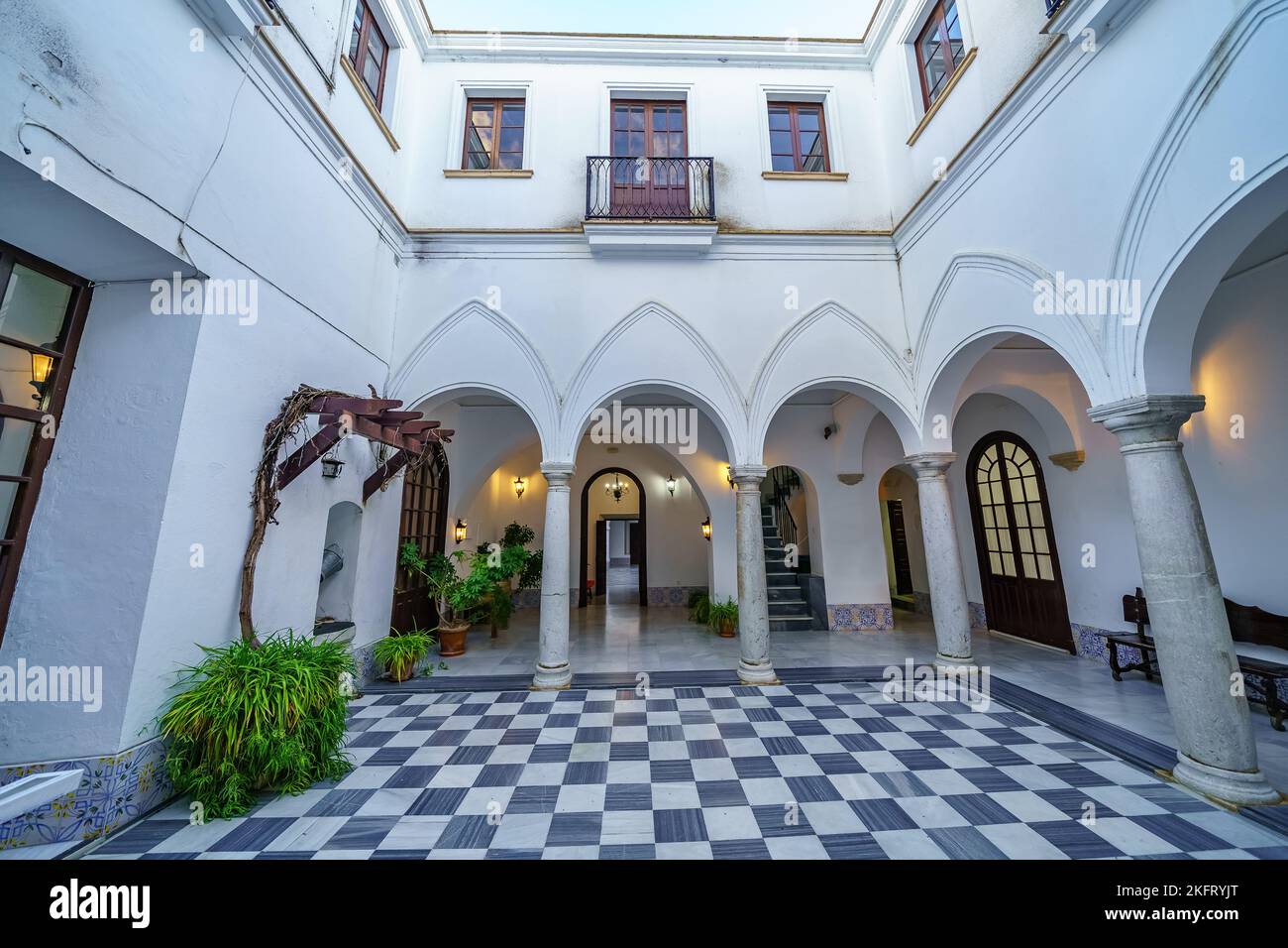 Nice Andalusian patio with arches and columns surrounding the space ...