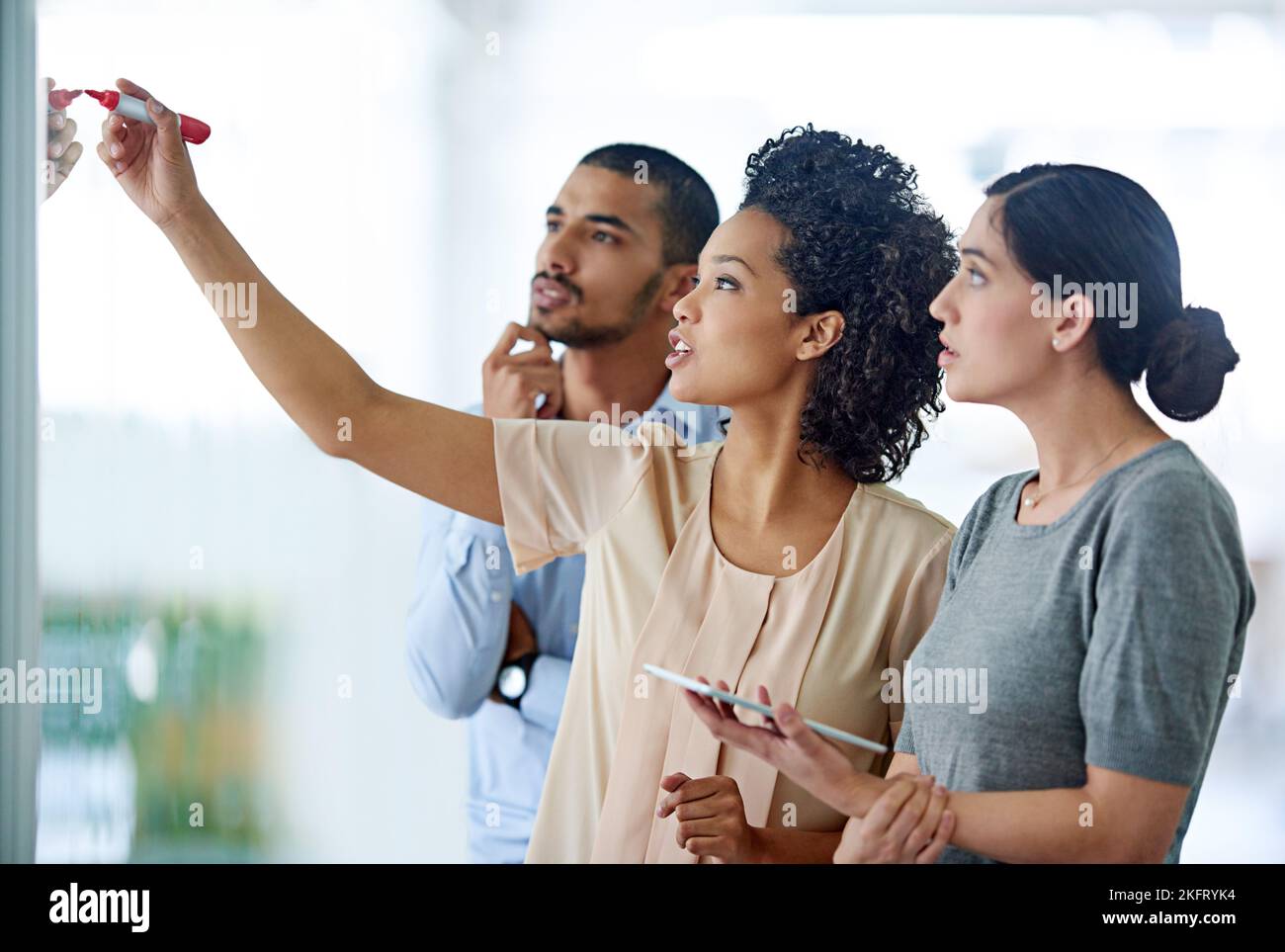 Getting it done together. a diverse group of coworkers brainstorming in ...