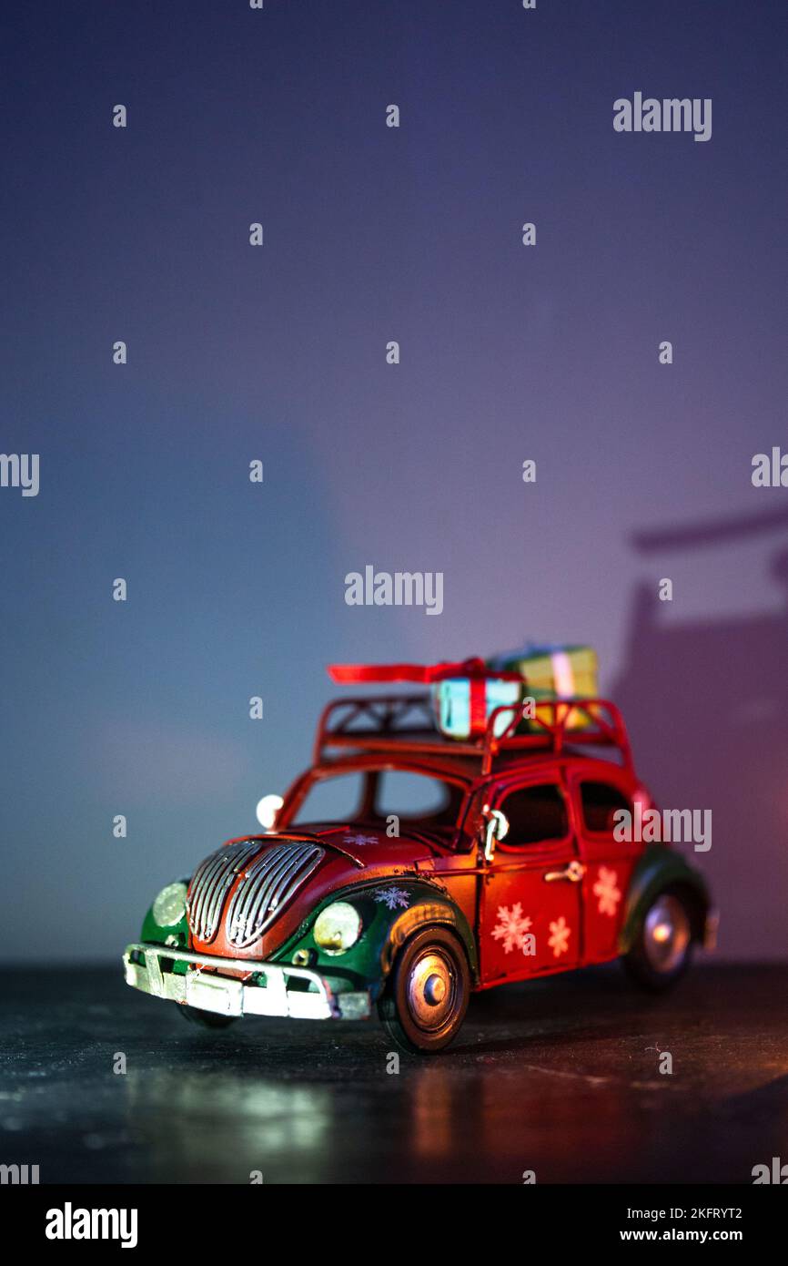 A small metal retro Christmas car with a gift box. Gift delivery ...