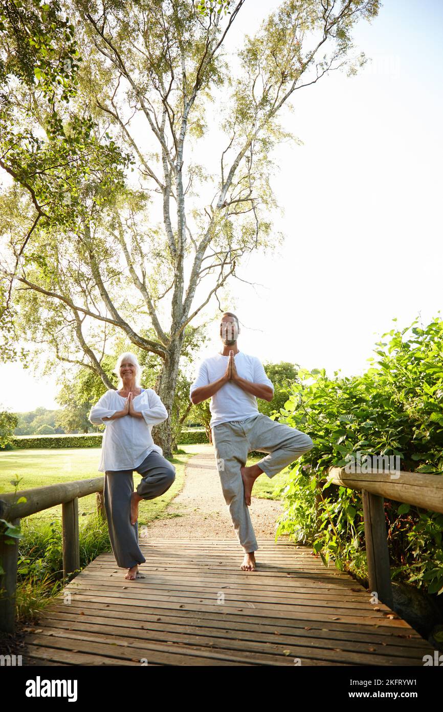 Its all about balance. Full length shot of a mature couple doing yoga ...