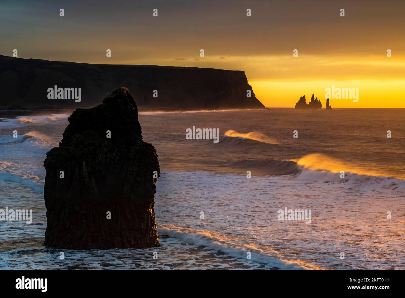 View from Cape Dyrhólaey at sunrise, rock formations Reynisdrangar and ...
