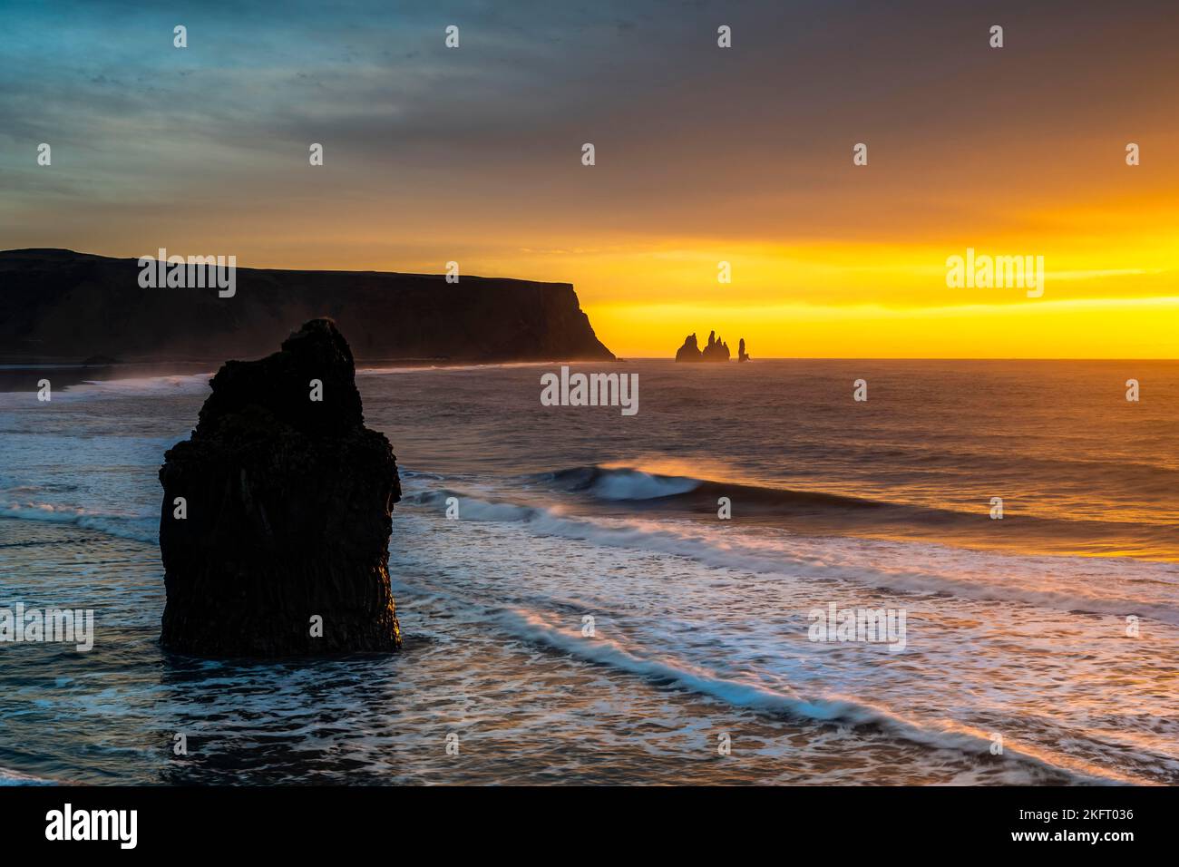 View from Cape Dyrhólaey at sunrise, rock formations Reynisdrangar and ...