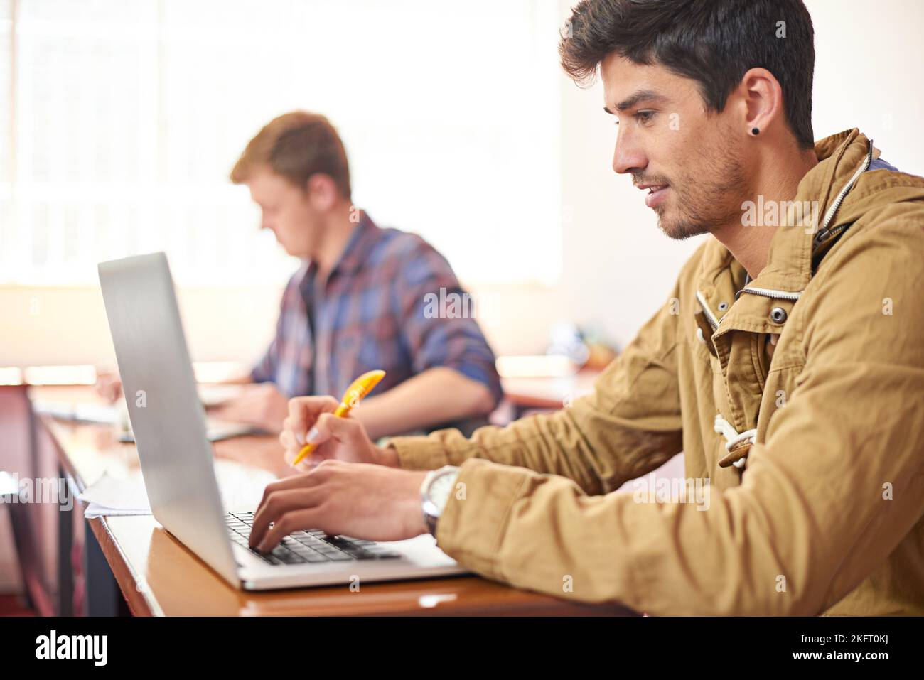 Classrooms that support modern technology. a student in class using a ...