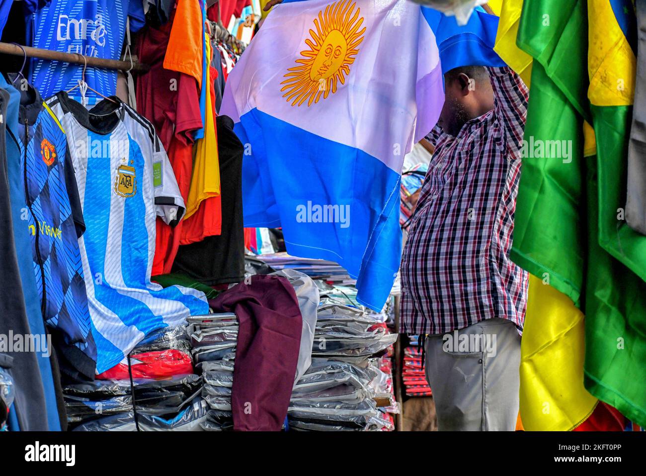 A shopkeeper displays jerseys of various participating countries in the ...