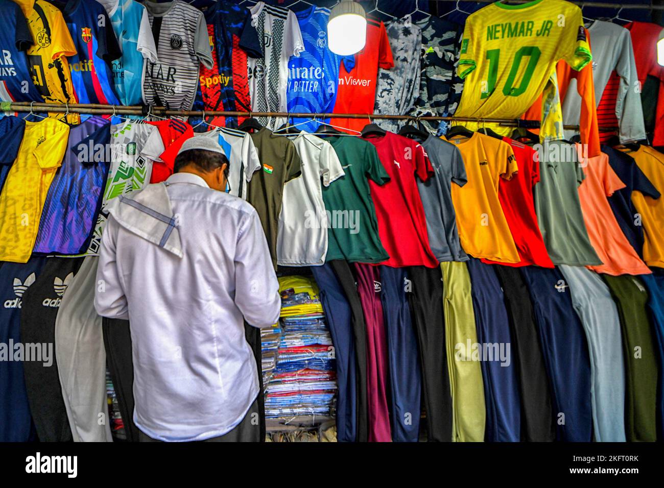 A shopkeeper displays jerseys of various participating countries in the ...