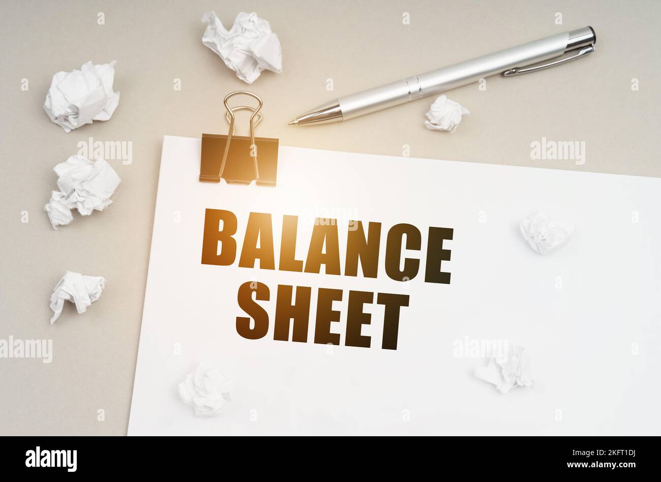 Economy and business concept. On a gray surface, a pen, crumpled paper ...