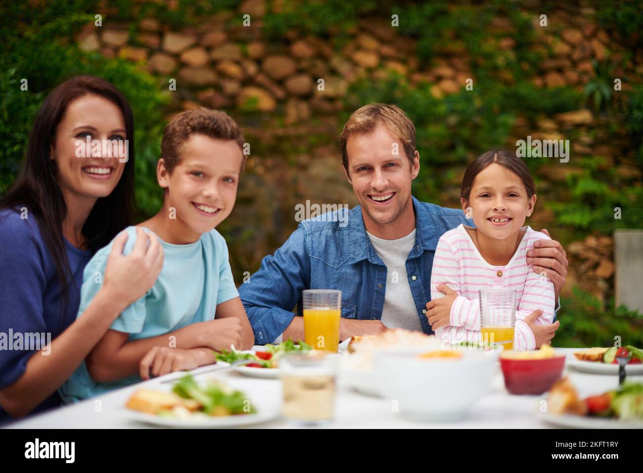 Encouraging healthy eating. Portrait of a smiling family enjoying a ...