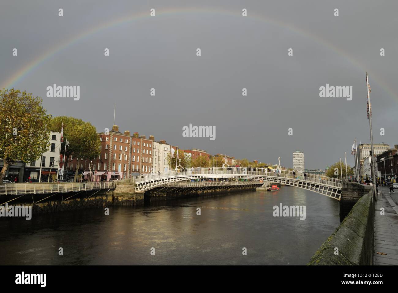 A rainbow over the River Liffey at the Hapenny Bridge, one of the ...