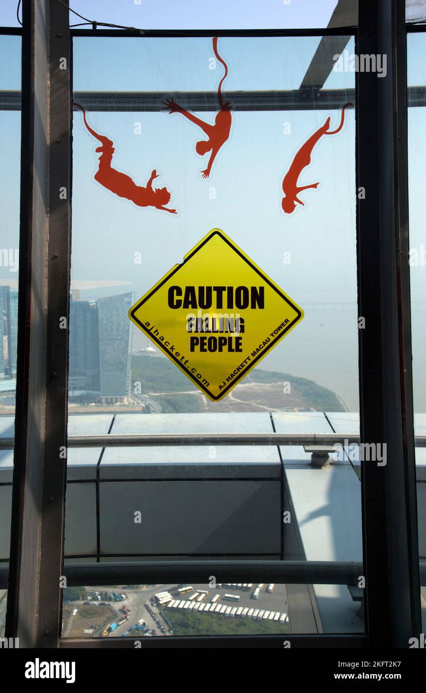 Sticker with the inscription, Attention falling people, in a window of ...