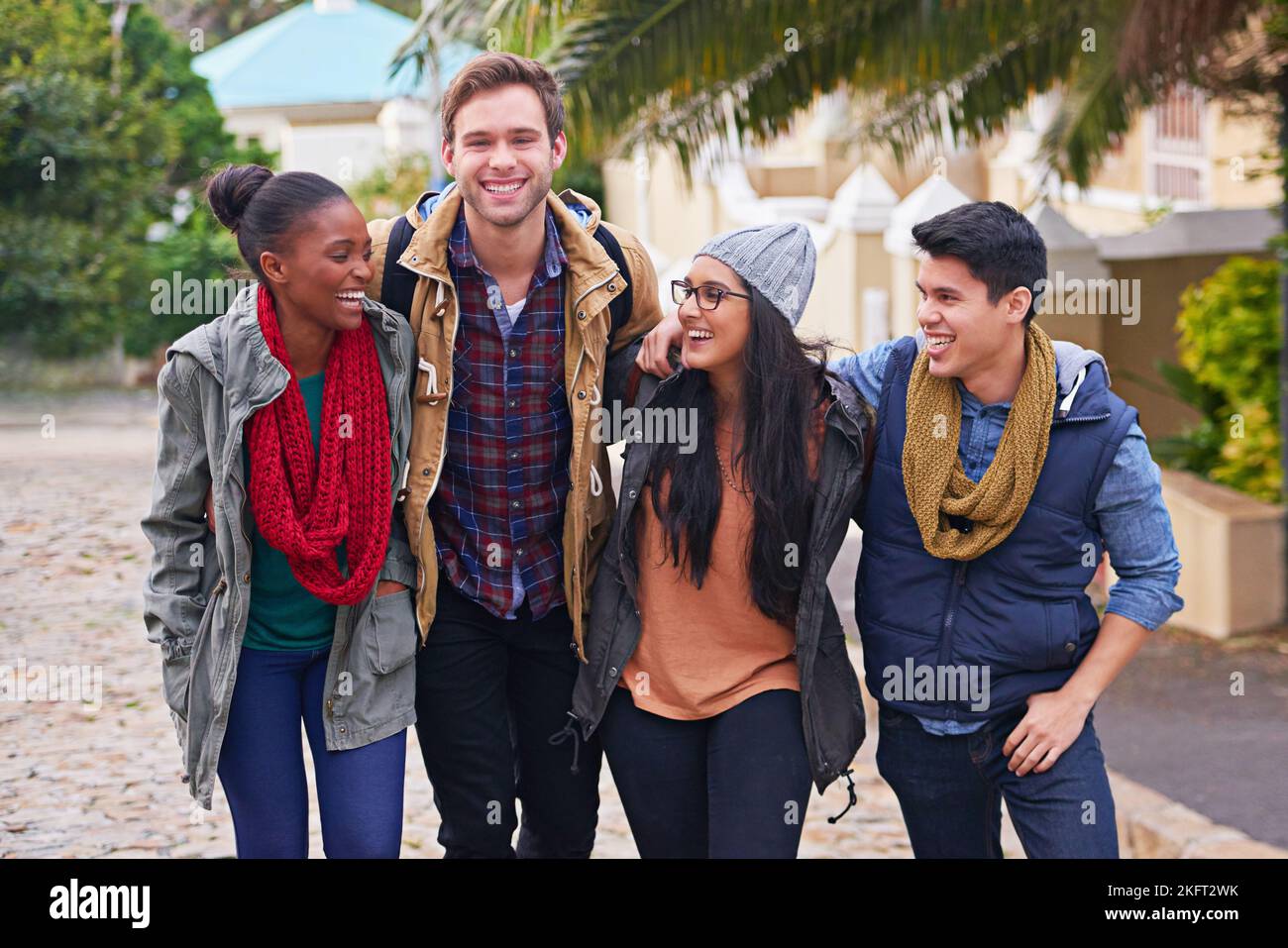 Enjoying their college experience. a group of happy college students ...