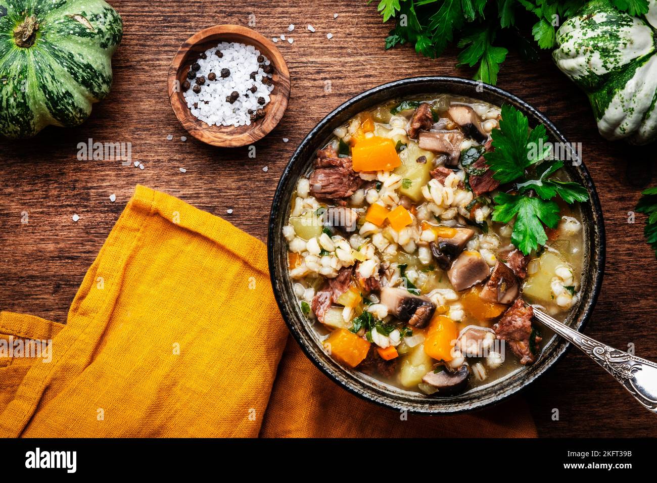 Autumn food. Warming soup with pumpkin, mushrooms, vegetables, beef and ...