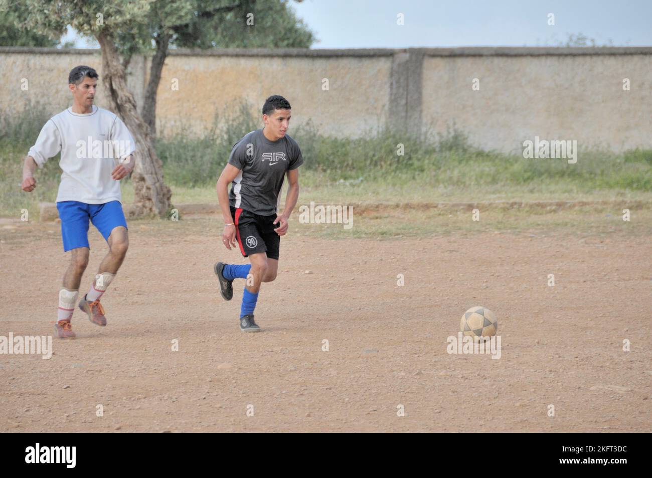 Men playing football, settlement of the poorer population outside Fes ...