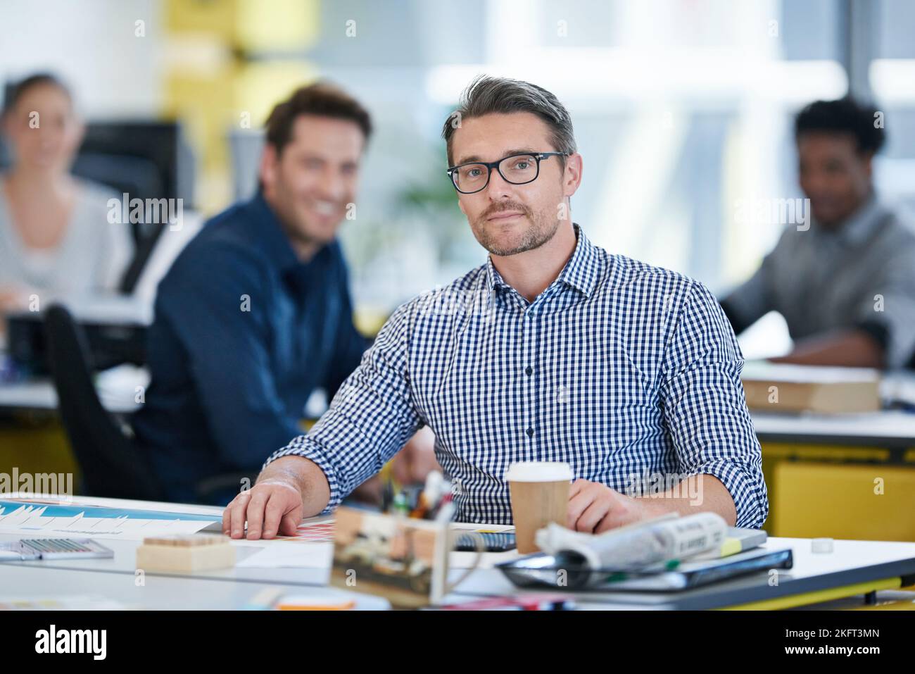 Behind every good manager is a great team. Portrait of an office worker ...