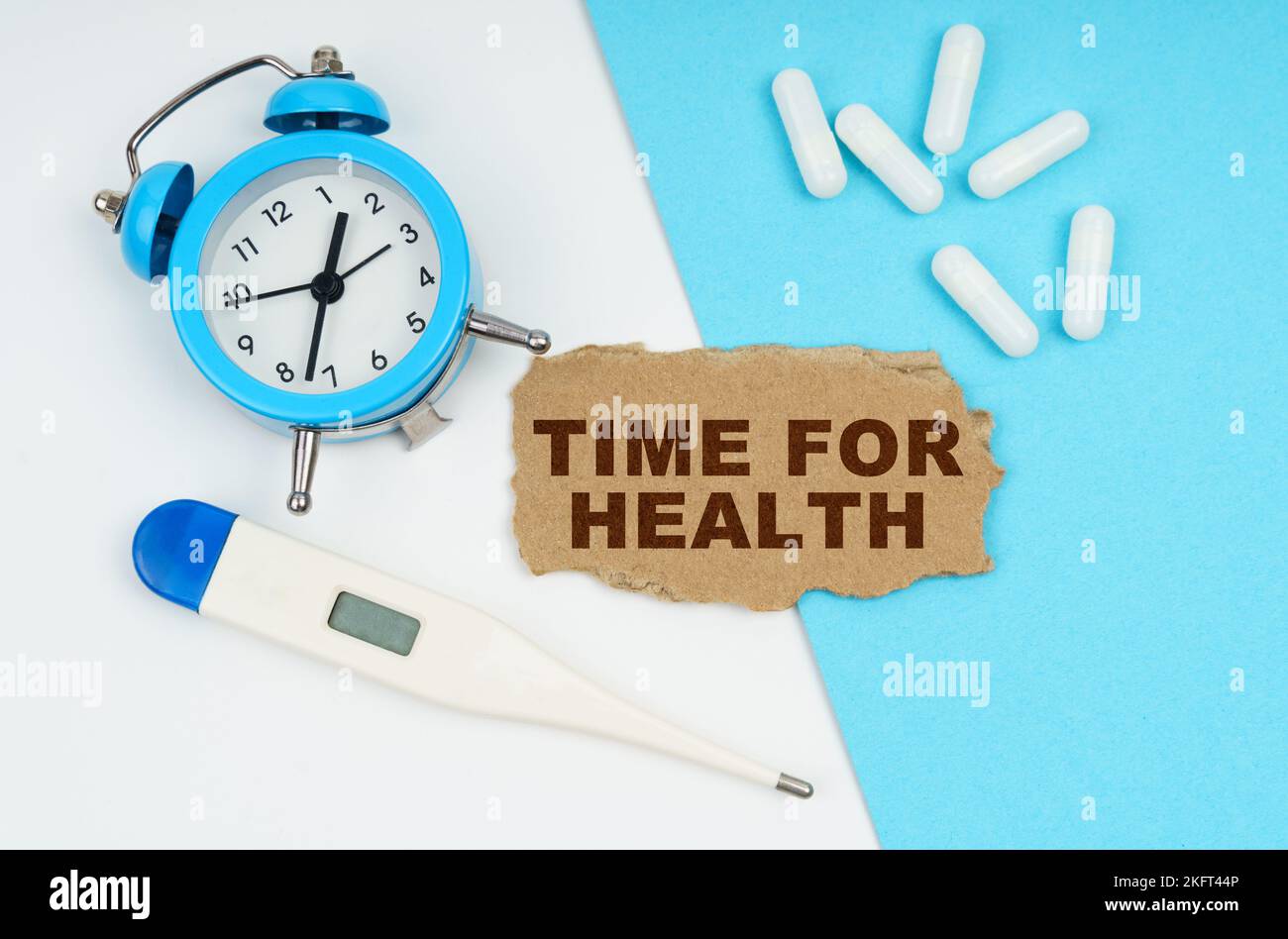 Medical concept. A clock, a thermometer, a syringe and a cardboard with ...