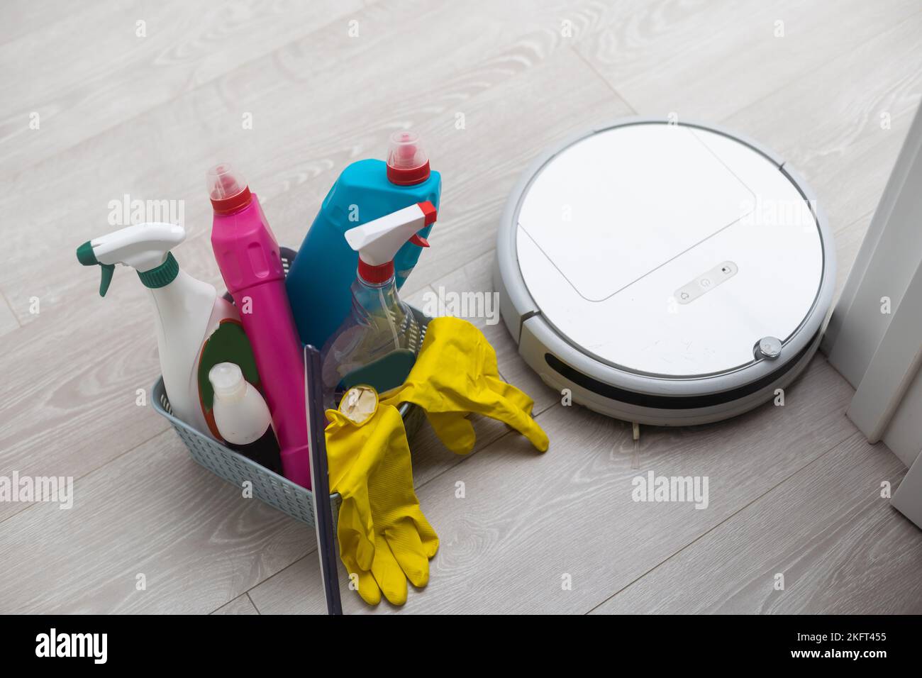 modern home cleaning products. Robot vacuum cleaner, cleaning sponges ...