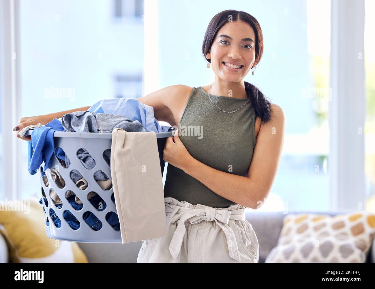 Washing, basket and portrait of a woman cleaning a modern house ready ...