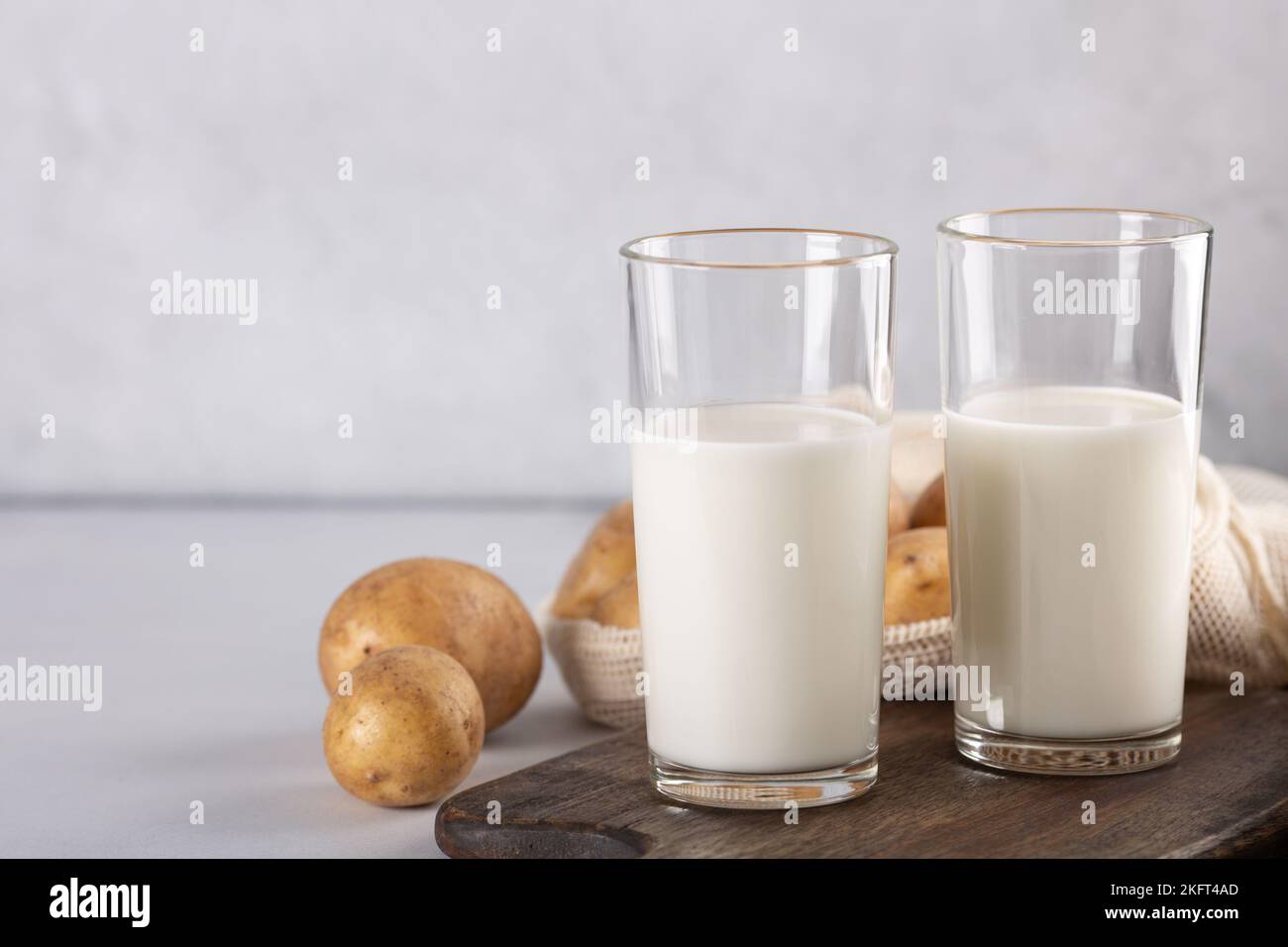 Vegan plant based milk in two transparent glasses. Alternative potato ...