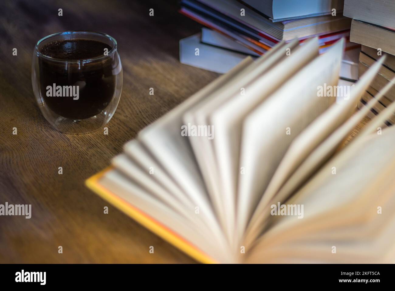 Stack of old books and coffee cup. Literature background. Open book and ...