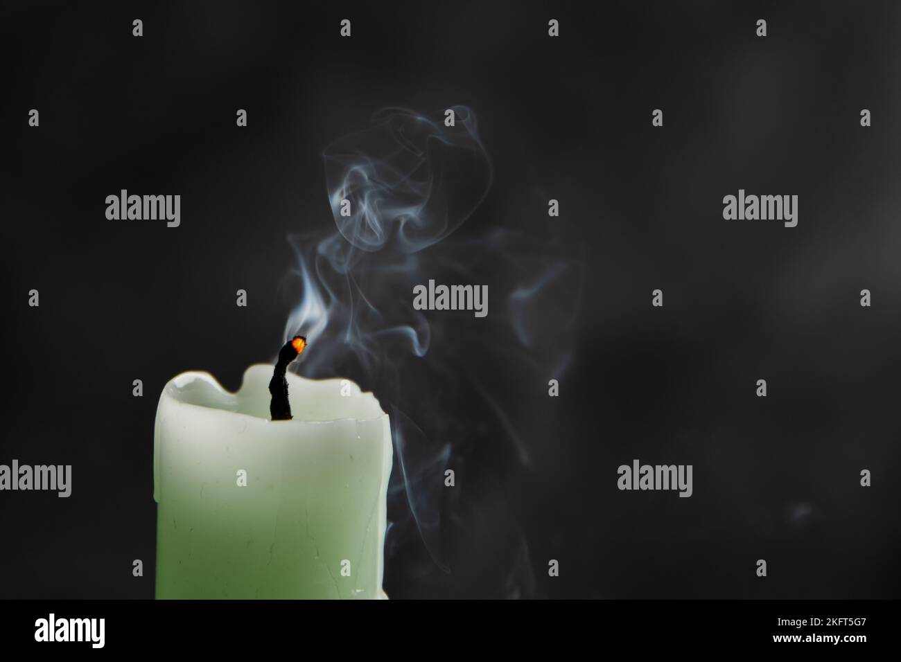 Extinct candle with smoke on a black background, symbol of death Stock ...