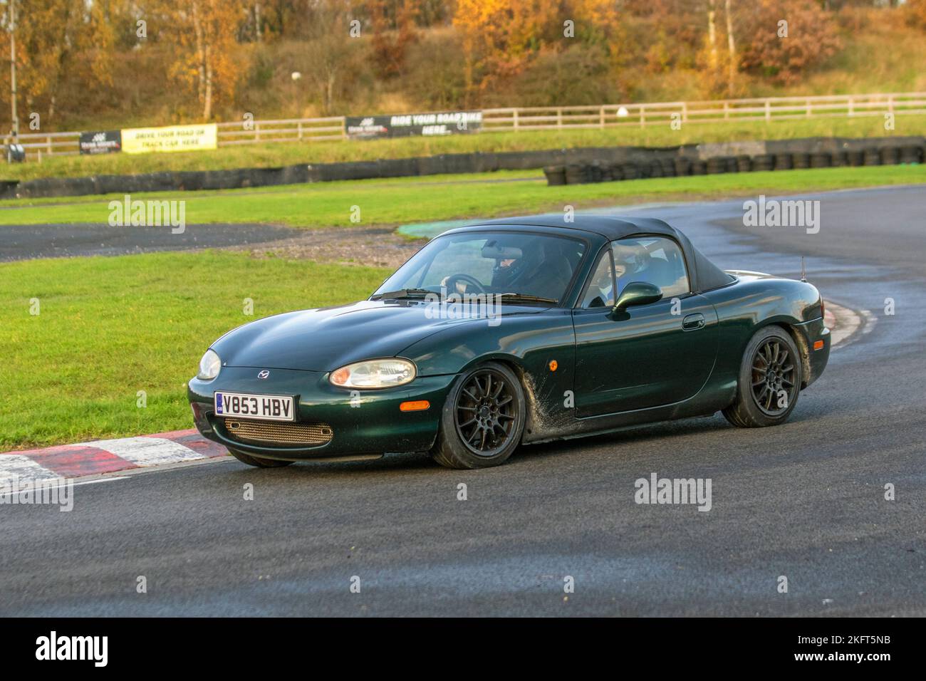 1999, 90s, nineties green Mazda Mx-5driving on challenging high-speed ...