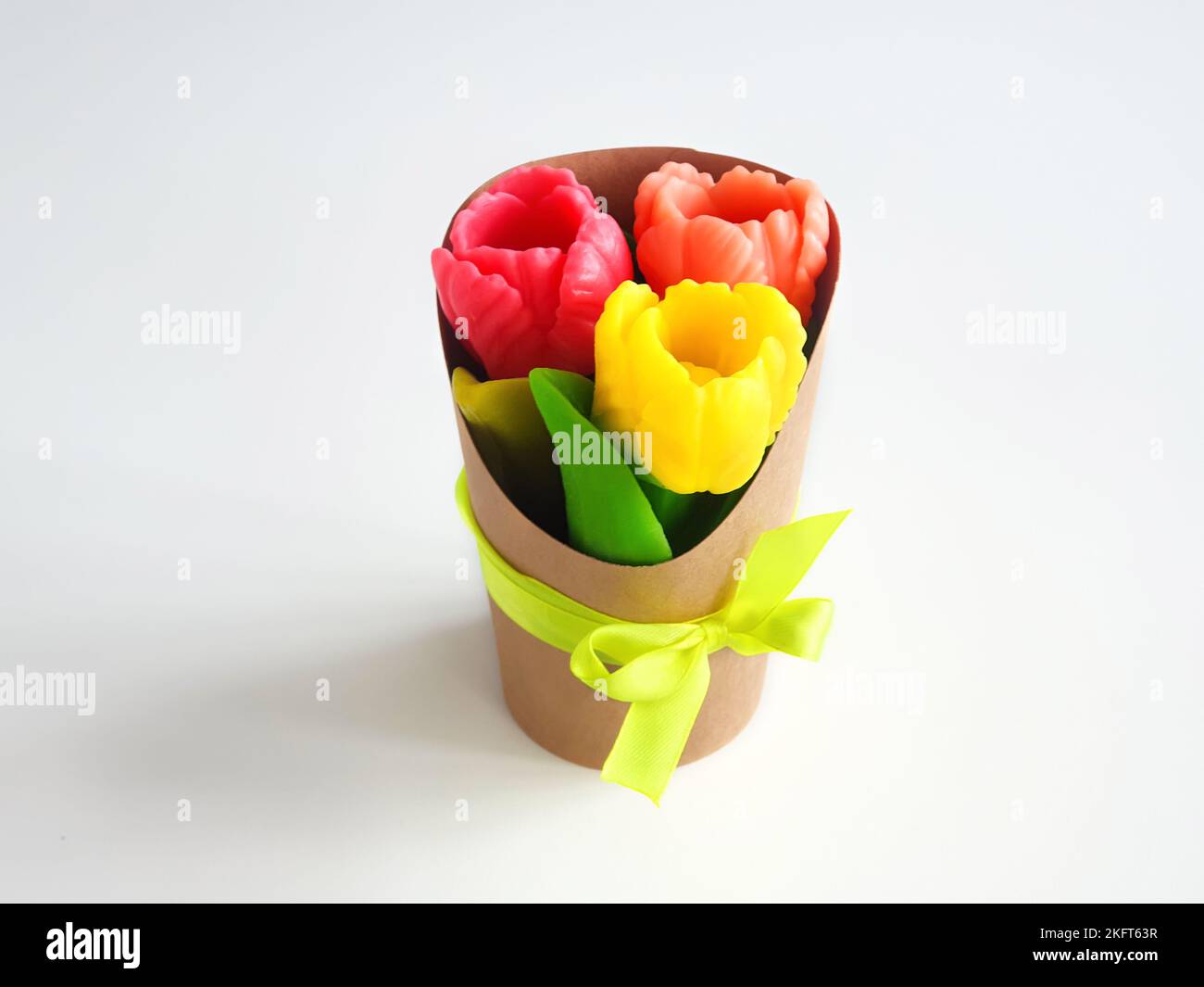 Pink, red and yellow tulips made from soap in gift box isolated on ...