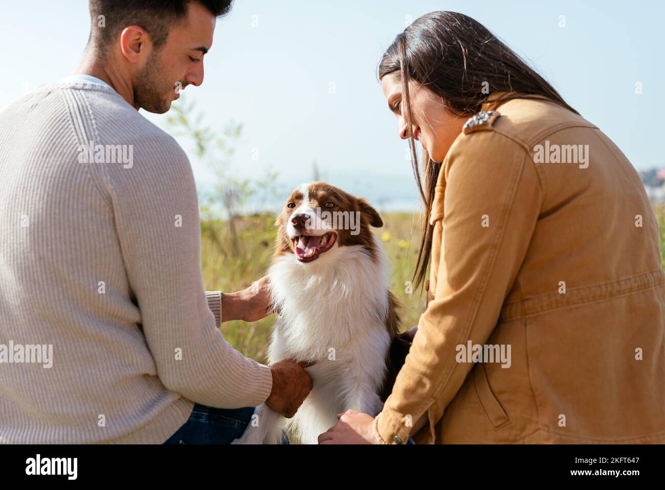 Back view of loving couple in casual clothes looking at each other ...