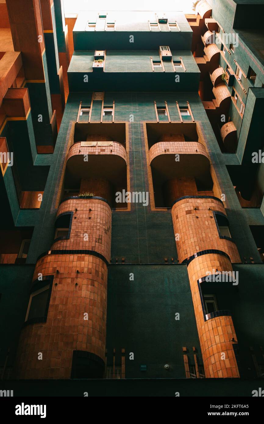 From below exterior of landmark building with brick wall balconies and ...