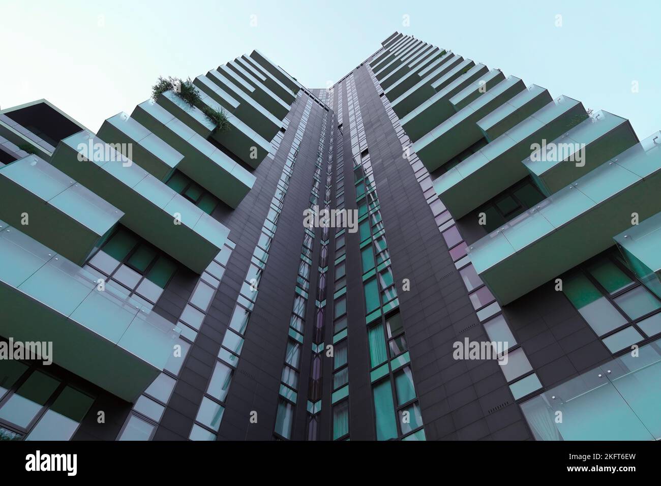 Low angle of futuristic glass skyscrapers located against dull sky on ...