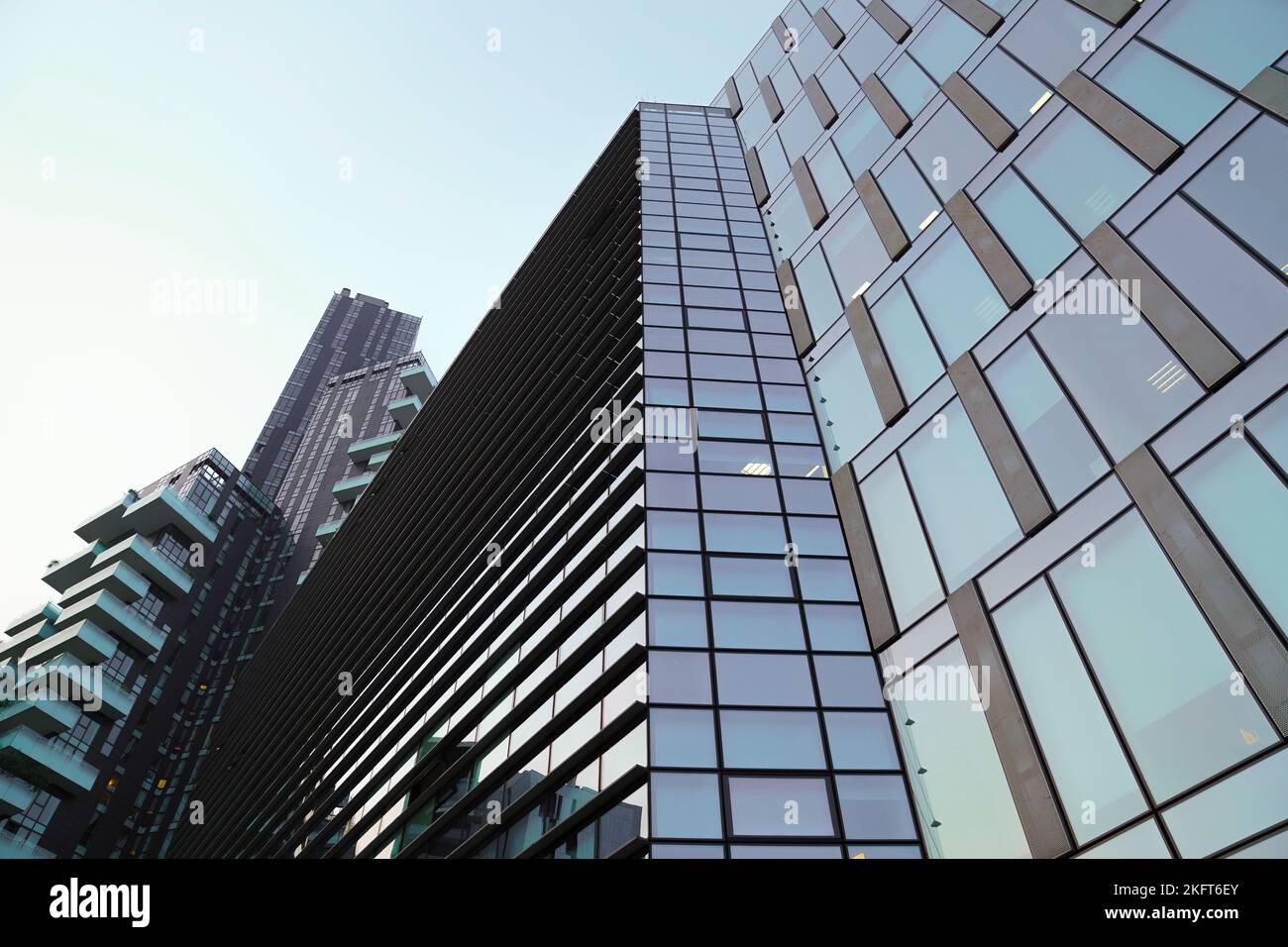 Low angle of futuristic glass skyscrapers located against dull sky on ...