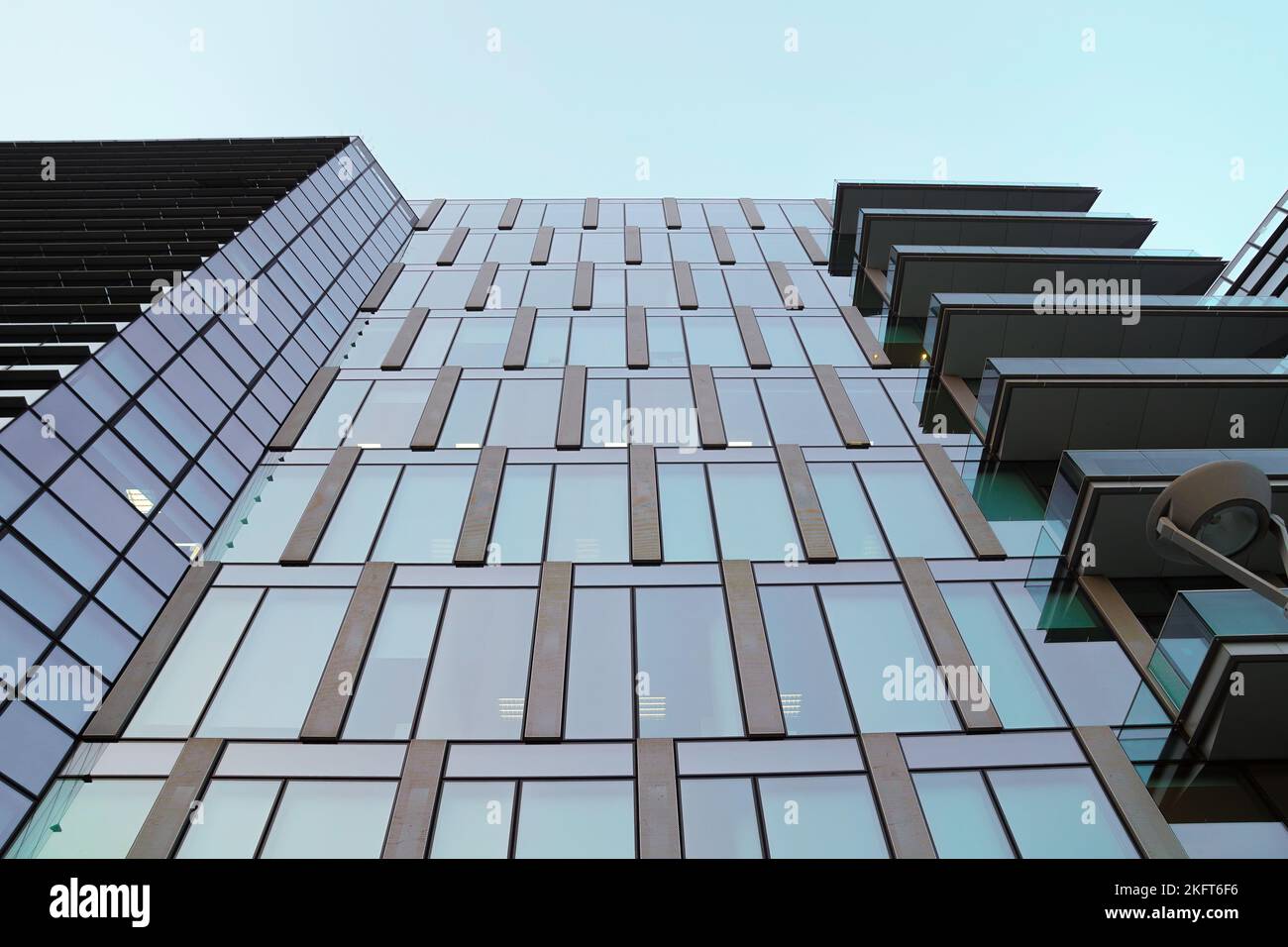 Low angle of futuristic glass skyscrapers located against dull sky on ...