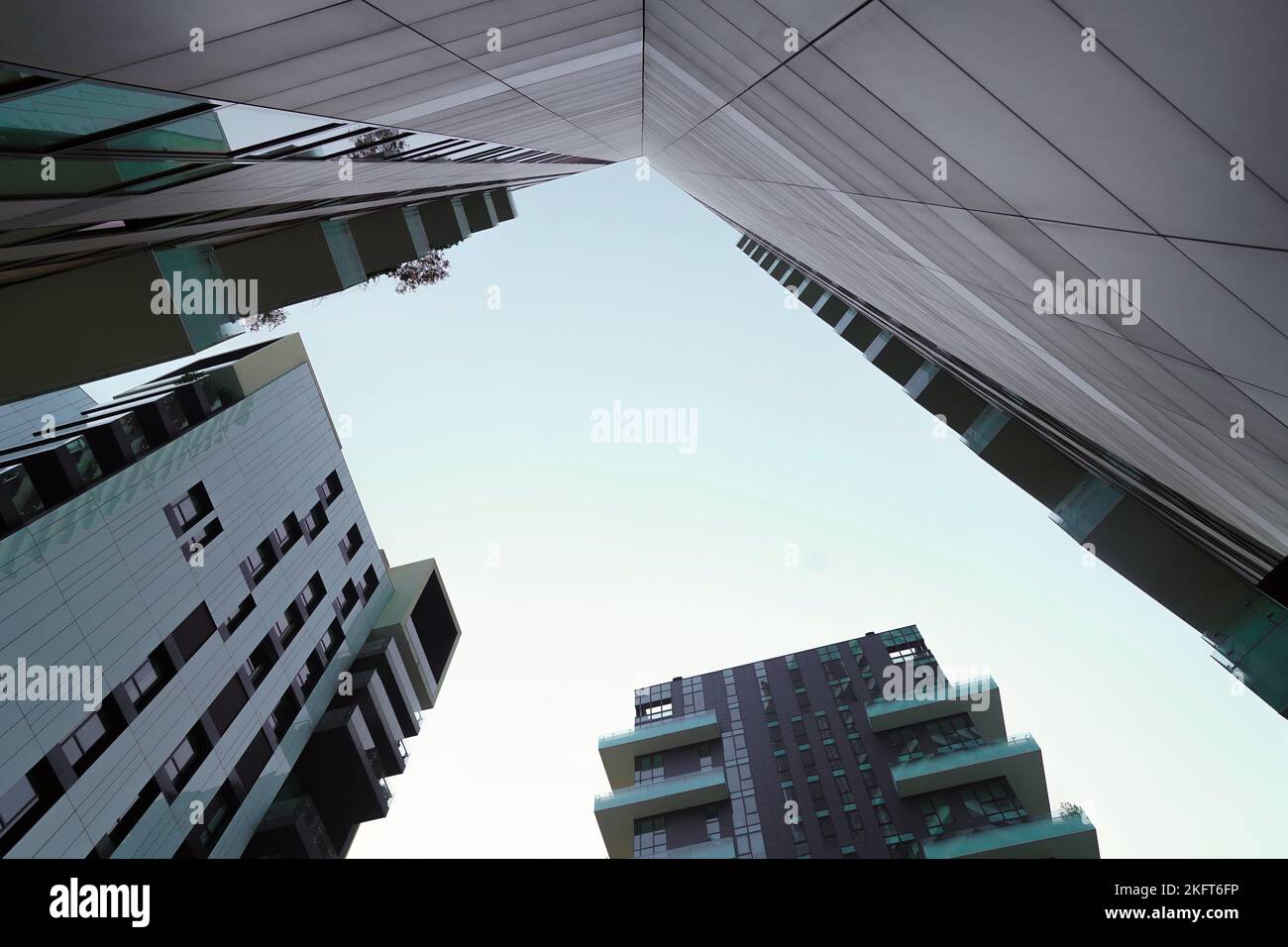 Low angle of futuristic glass skyscrapers located against dull sky on ...