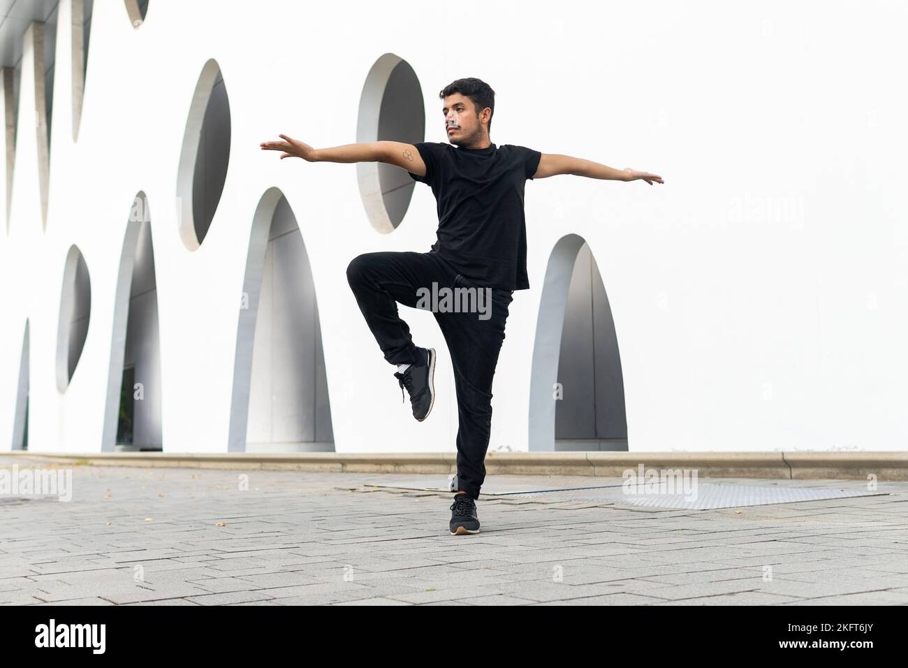 Full body of male dancer in black casual outfit performing dance ...