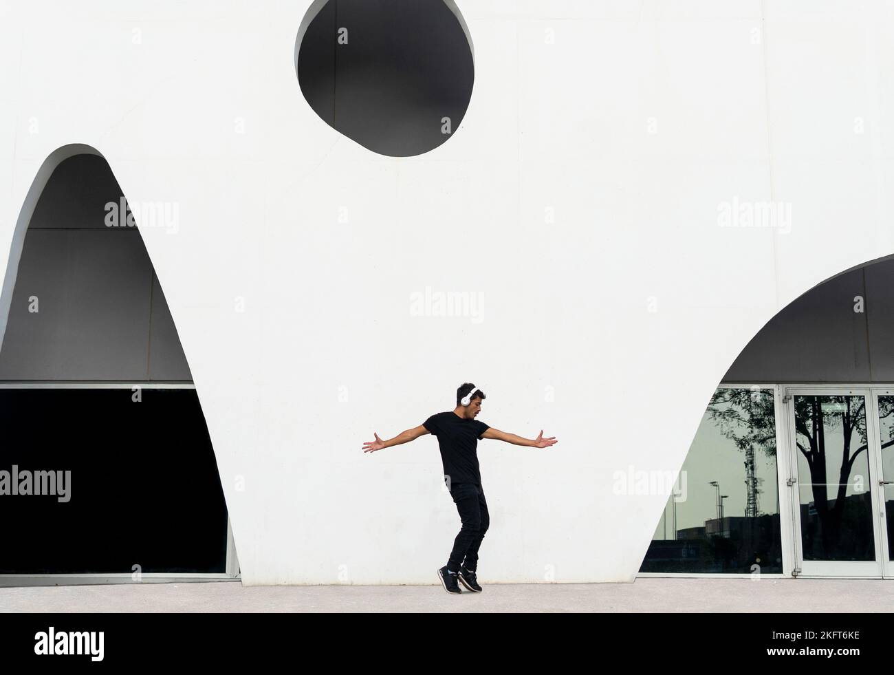 Full body of male dancer in black casual outfit performing dance ...