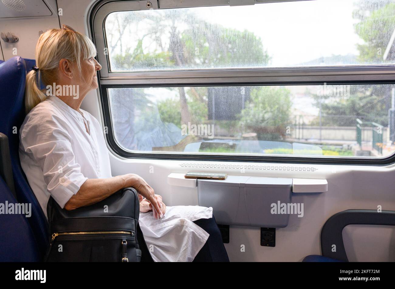 Elderly looking out train window hi-res stock photography and images - Alamy