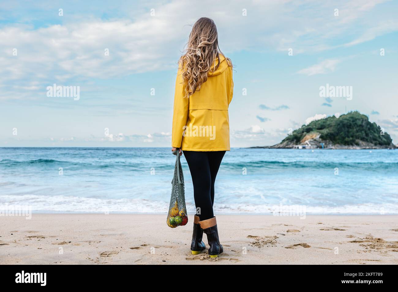 Anonymous female tourist in yellow hi-res stock photography and images ...