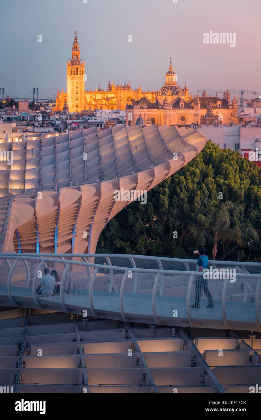 Giant symmetrical roof of modern construction near old towers of ...