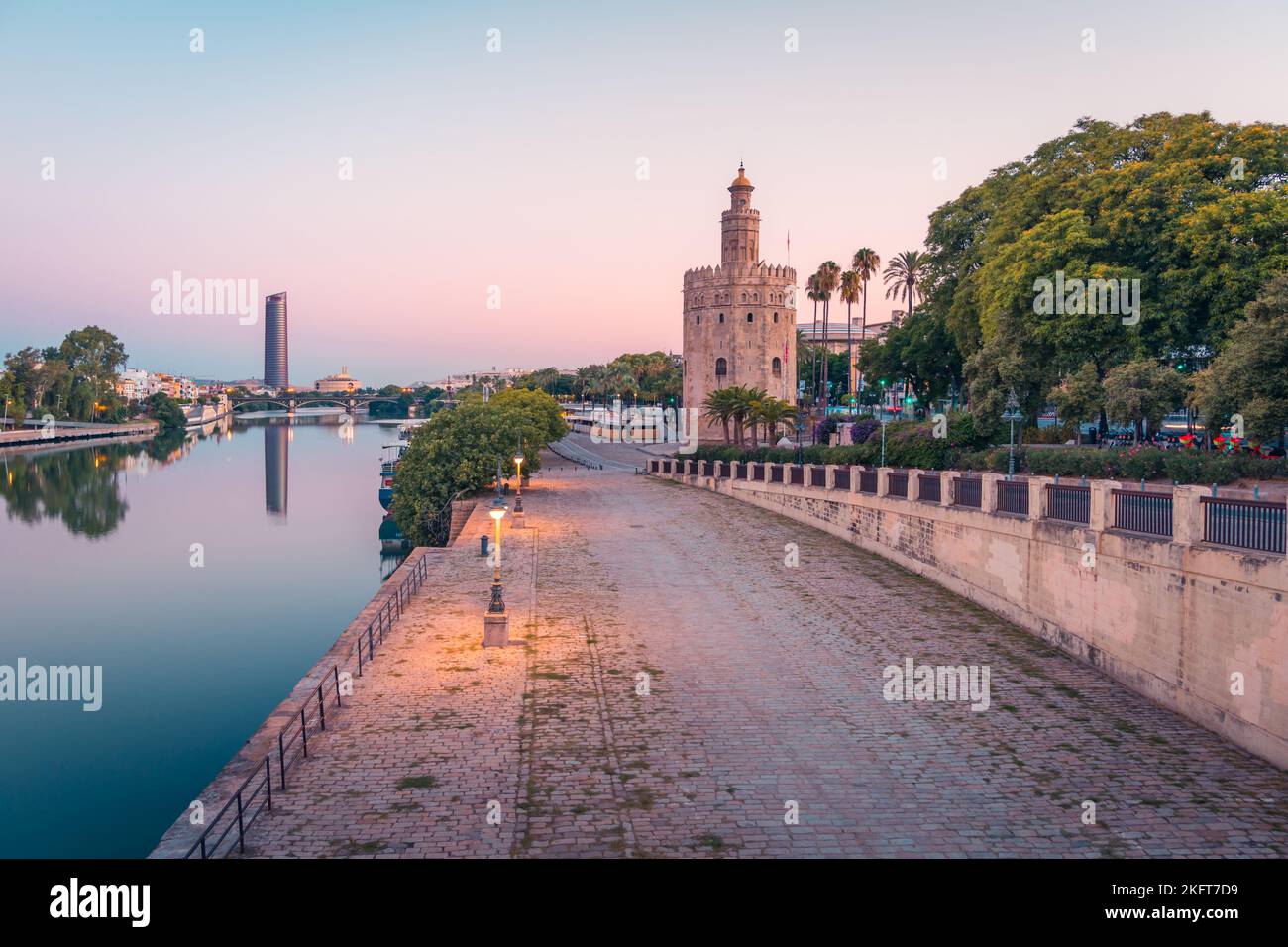 Calm water of river with embankment covered with green trees ...