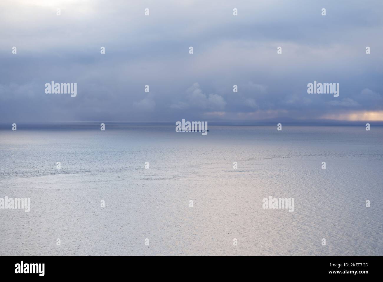 Scenic view of ripping ocean waves under blue cloudy sky on overcast ...