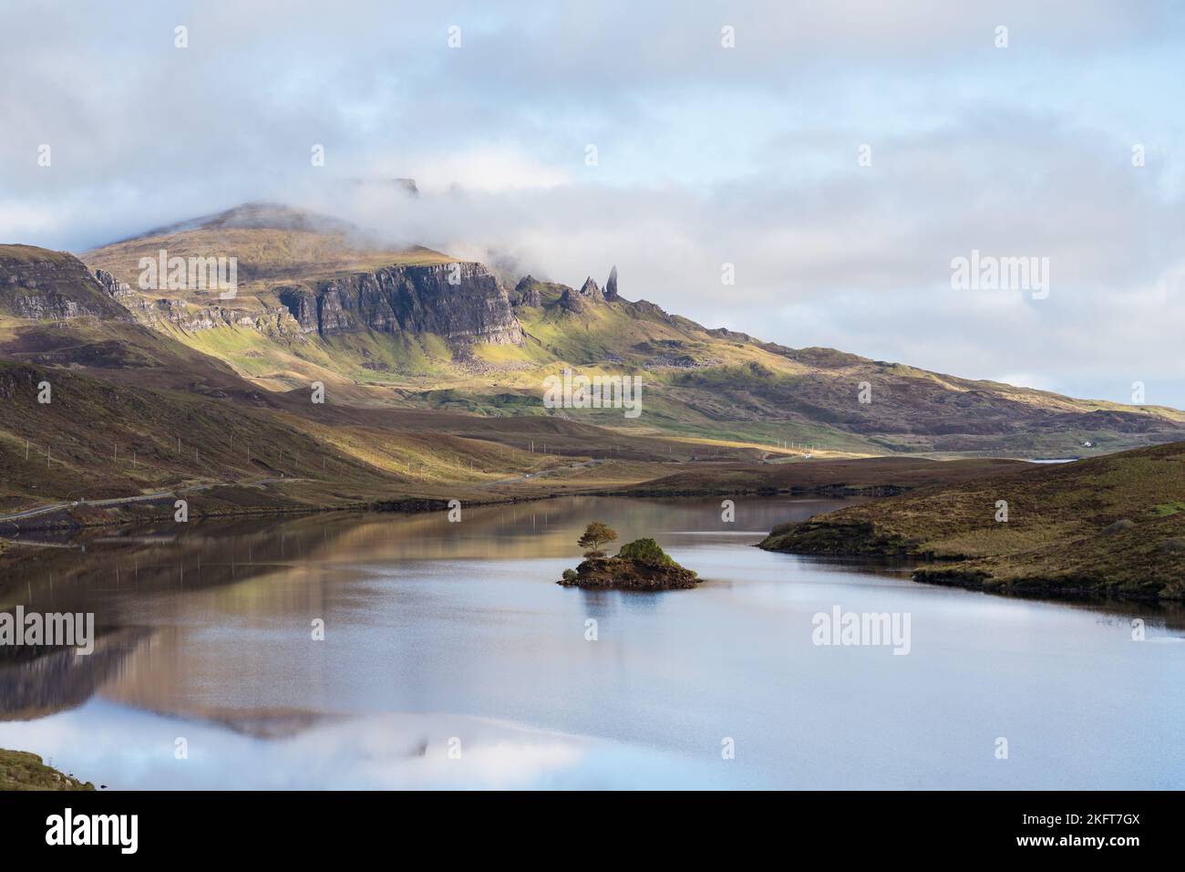 Picturesque view of Loch Fada lake near hills covered with grass under ...