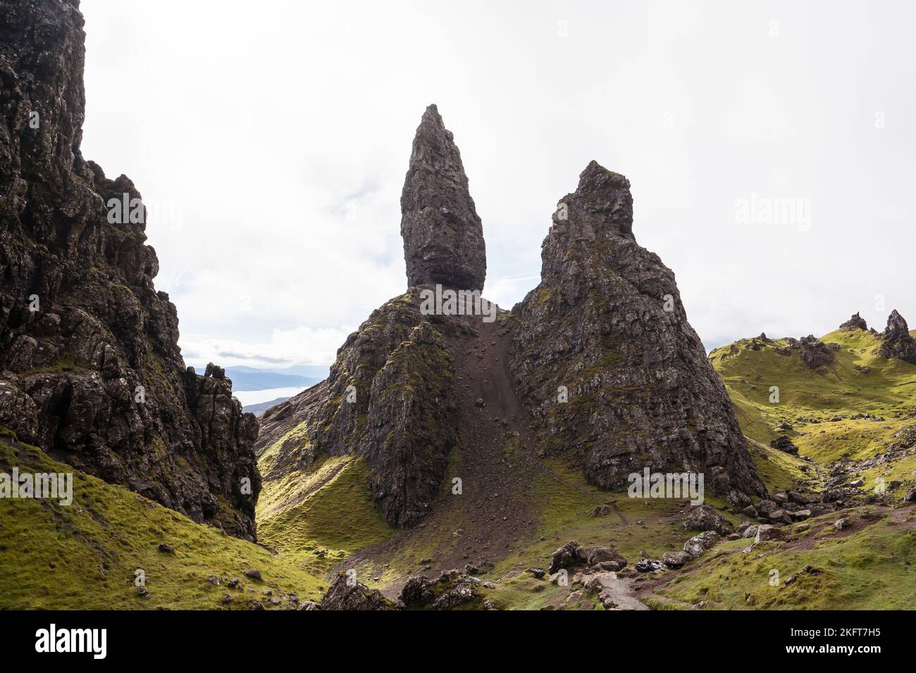 Famous rock sculpture of Old Man of Storr on grassy hill located in ...